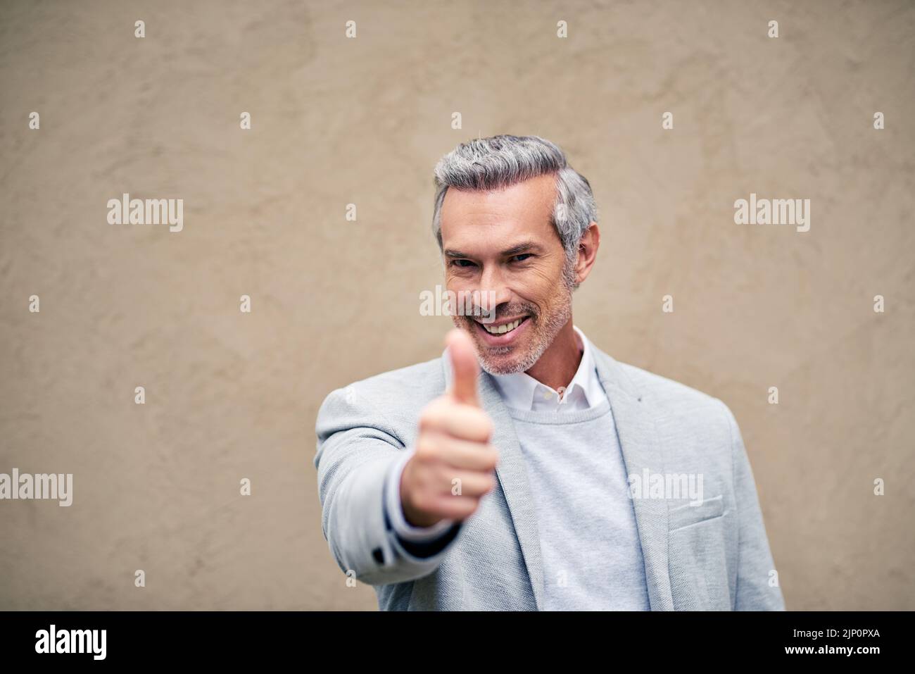 Thumbs up to looking presentable all the time. a smartly dressed mature ...