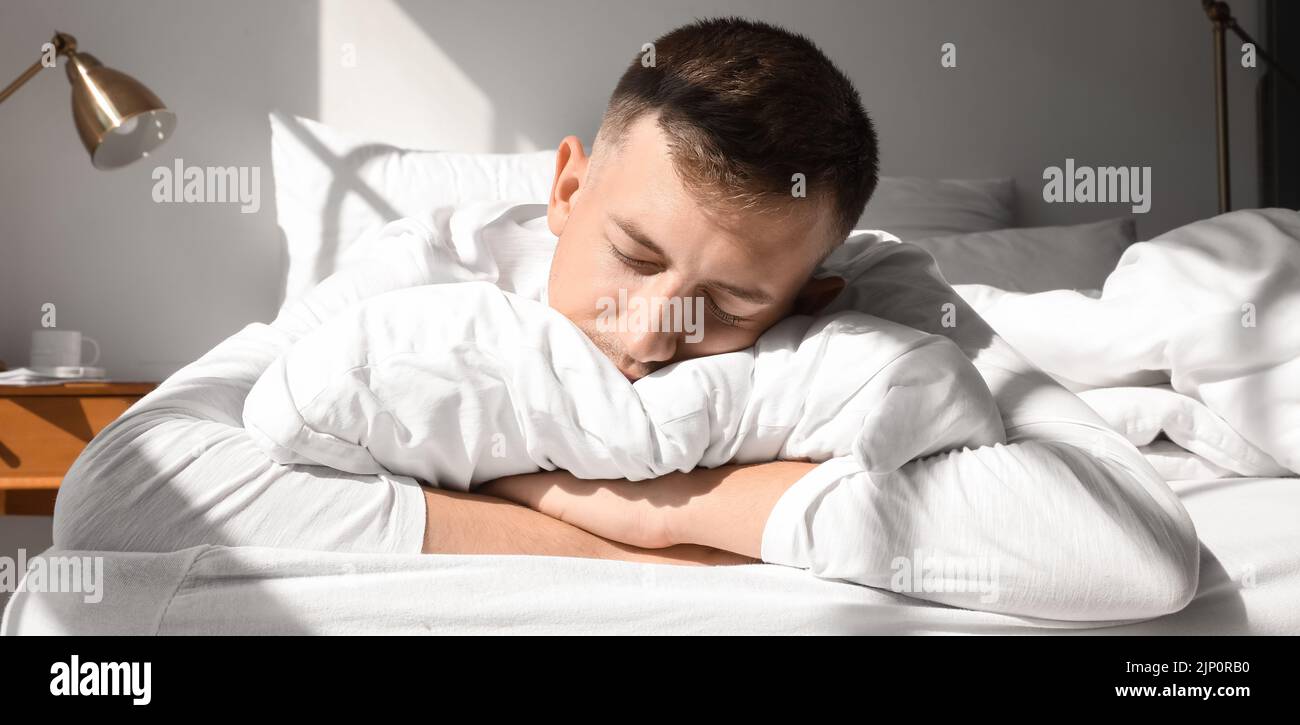 Morning of young man sleeping in bed Stock Photo - Alamy