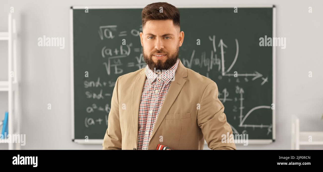 Portrait of male math teacher in classroom Stock Photo - Alamy