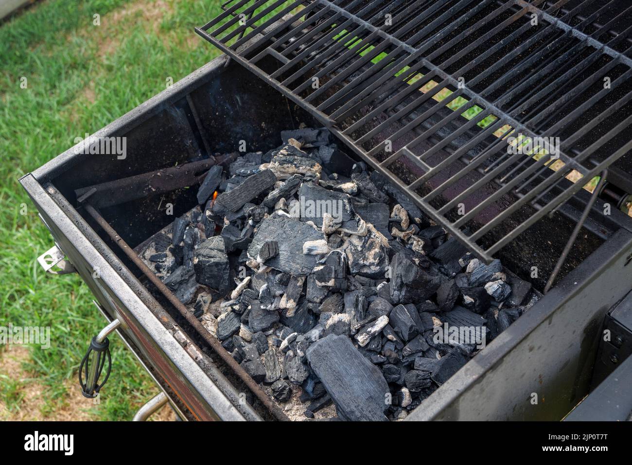 Home barbecue with charcoal in the backyard grilling steaks and other ...