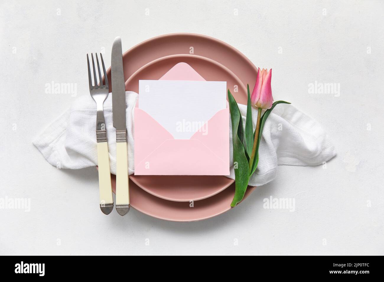 Simple table setting with tulip on white background Stock Photo - Alamy