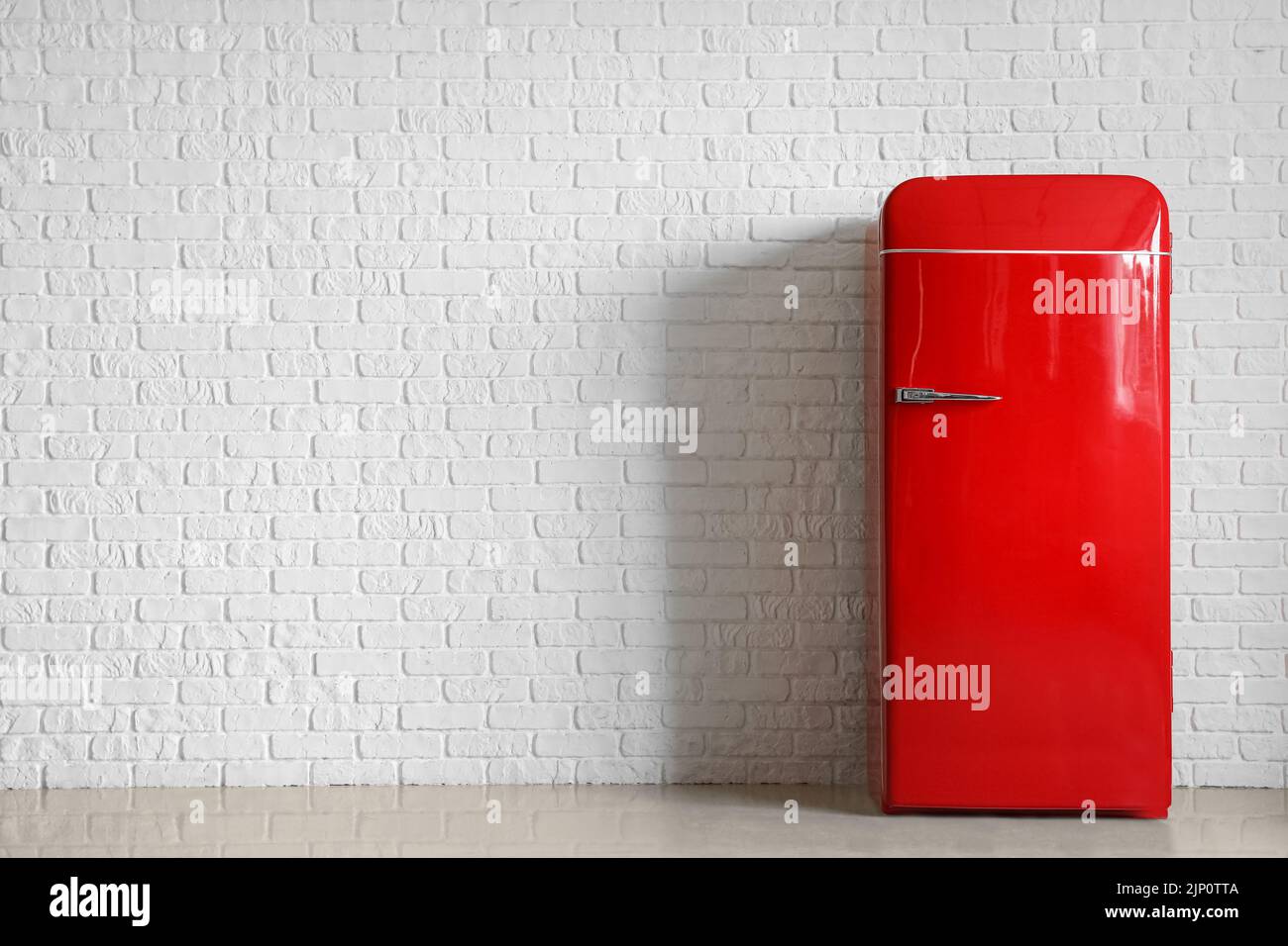 Stylish retro fridge near white brick wall Stock Photo - Alamy