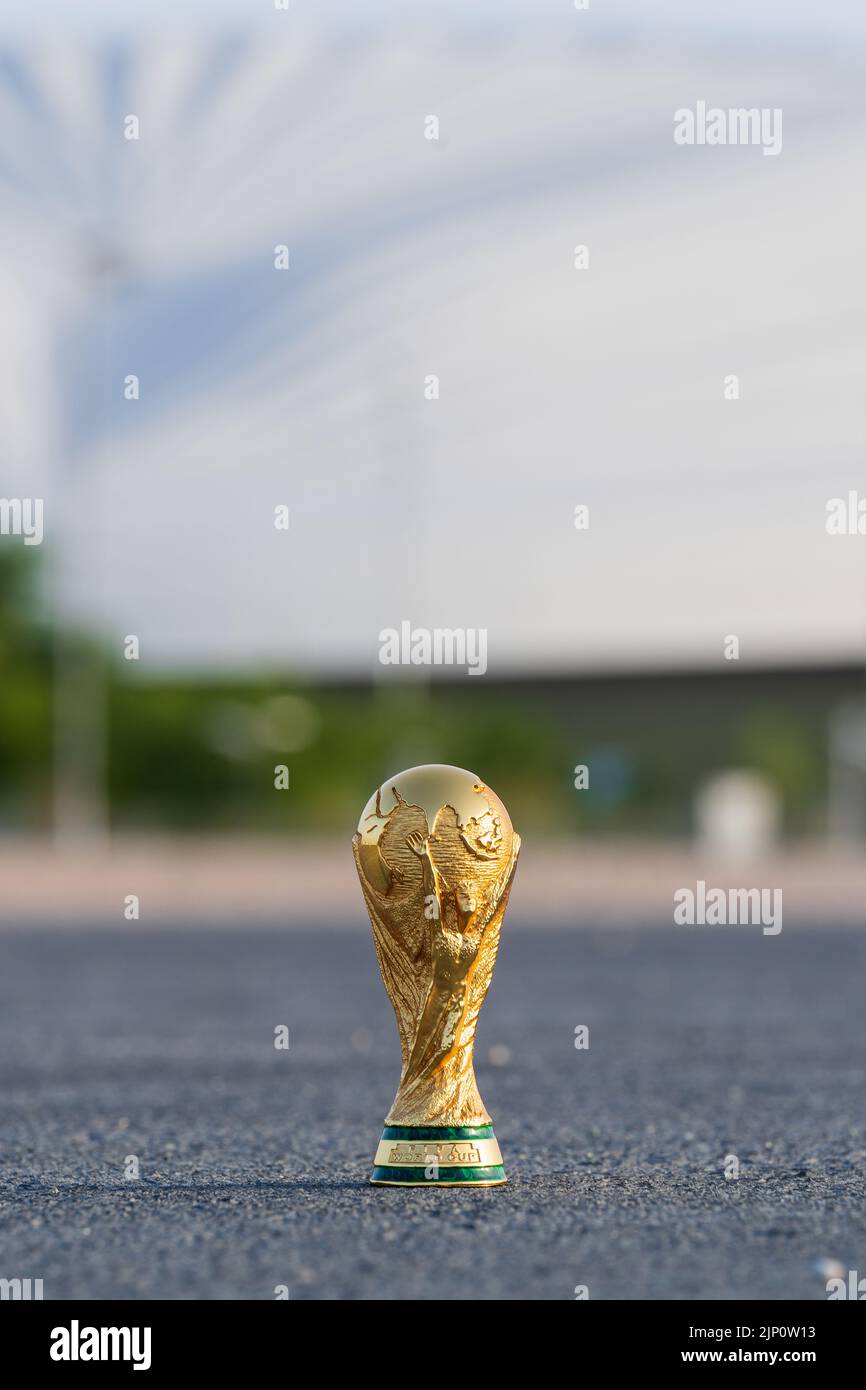 DOHA, QATAR - AUGUST 14, 2022: Trophy of the FIFA World Cup against the ...