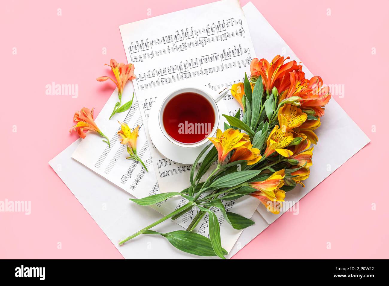 Composition with cup of tea, alstroemeria flowers and music notes on ...