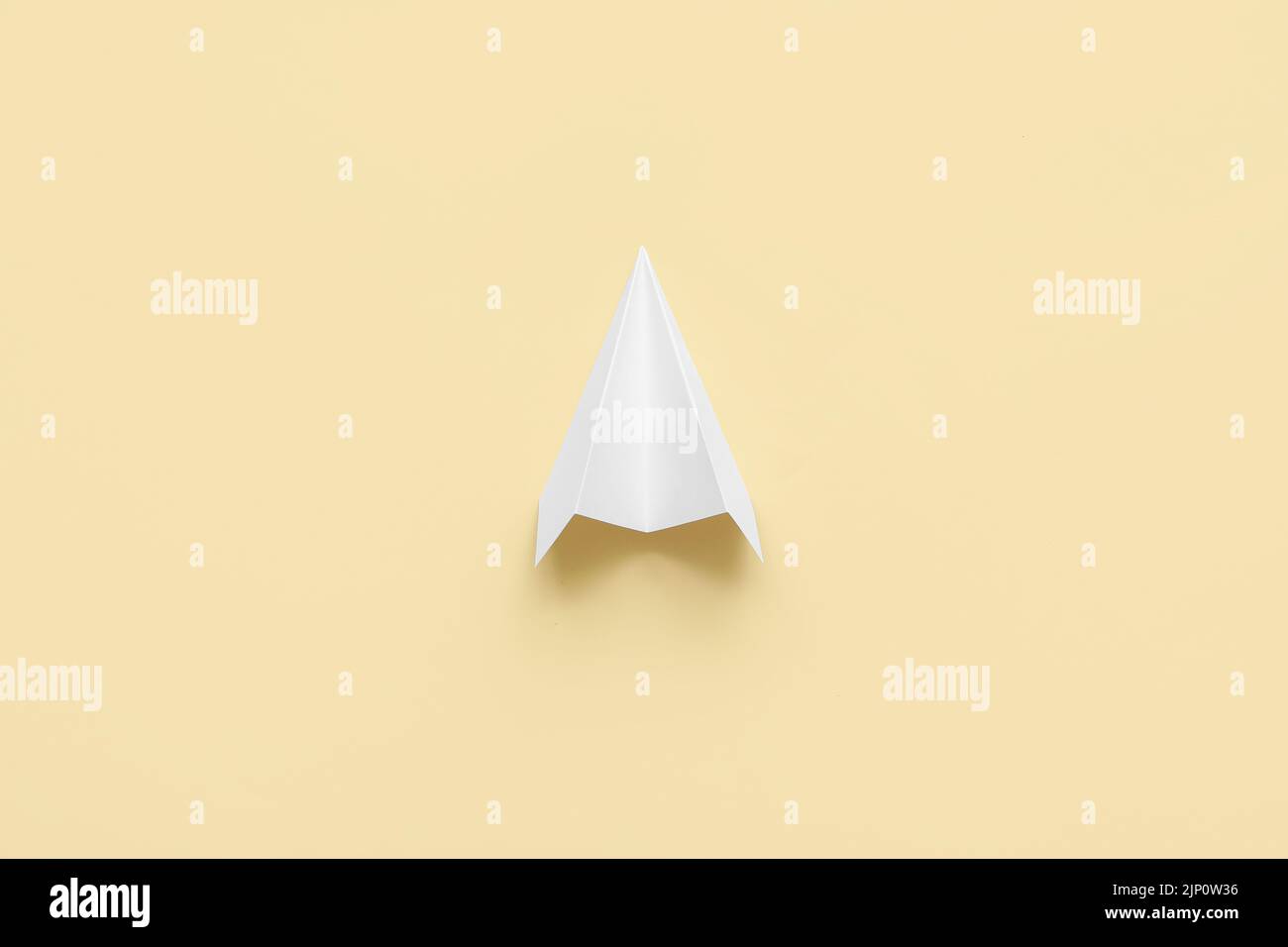 White paper plane on beige background Stock Photo - Alamy