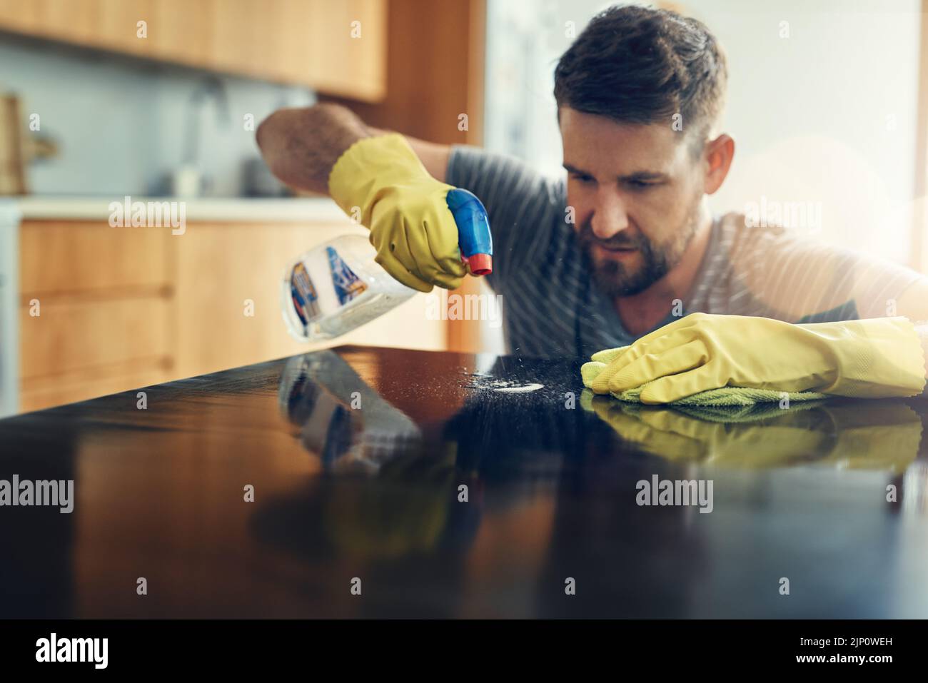 Germs, I will find you and I will eliminate you. a young man cleaning ...