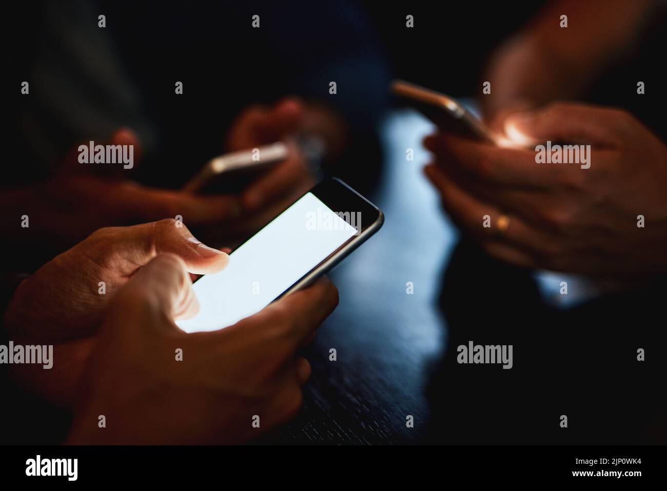 Texting everyone to come and join us. Closeup of a group of ...