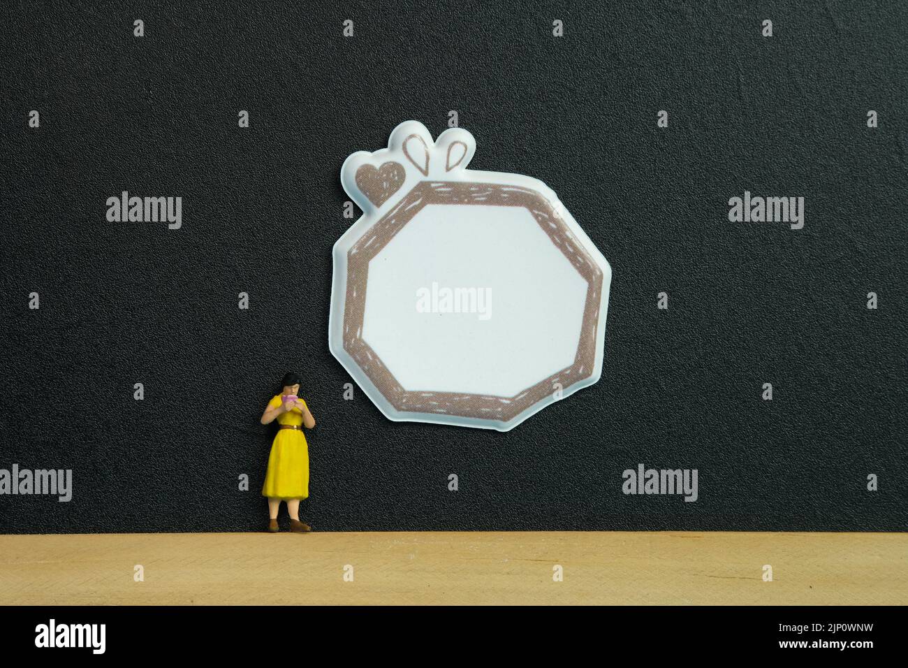 Miniature people toy figure photography. A girl reading a book above ...