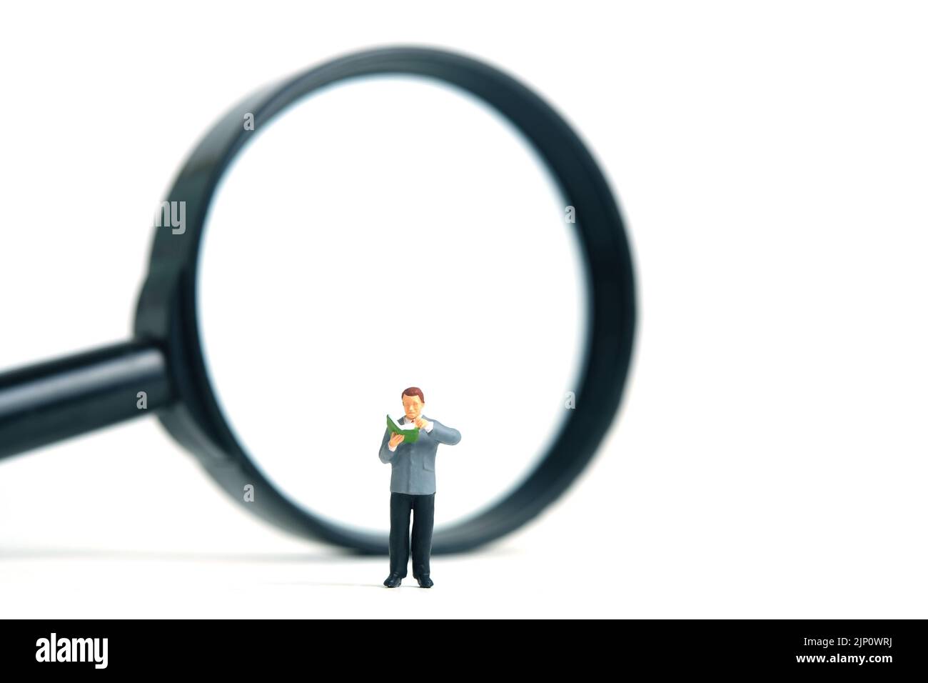 Miniature people toy figure photography. A men student standing in ...