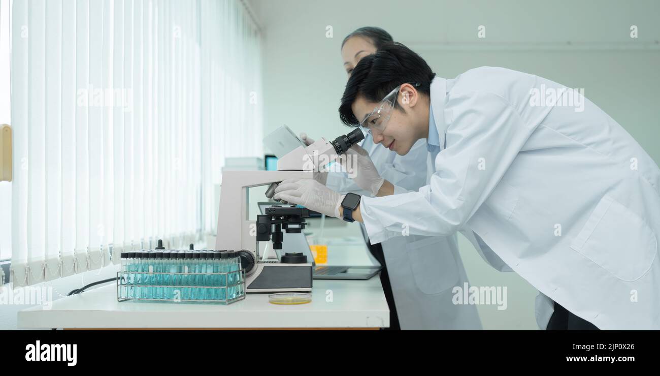 Group of science researchers working with test tube medical science ...