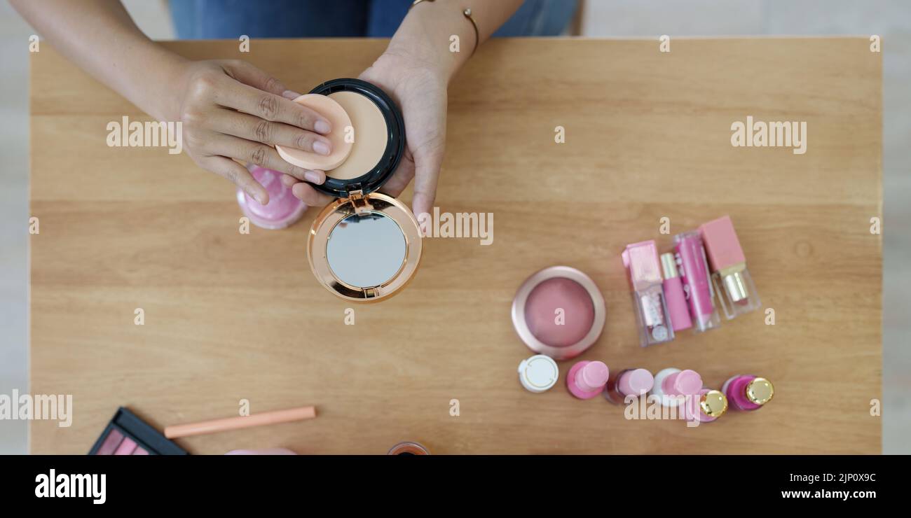 Woman using cosmetic and try to make up following her vlogger Stock ...