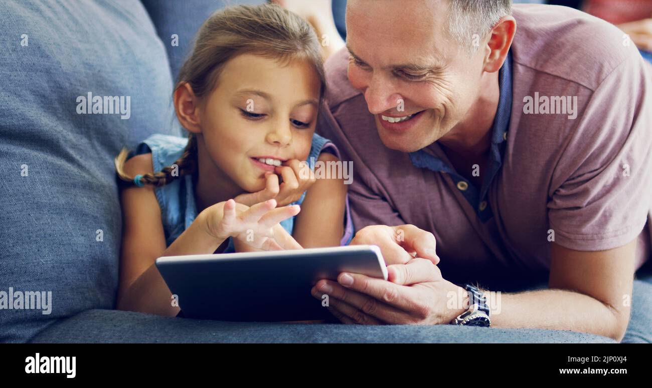 Learning about the ways of a wireless world. a cute little girl using a ...