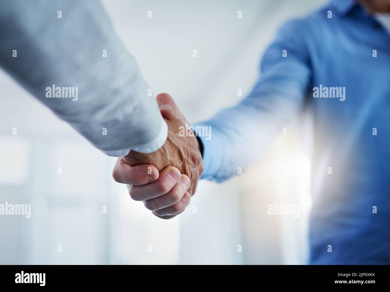Two businessmen shaking hands partnering hi-res stock photography and ...