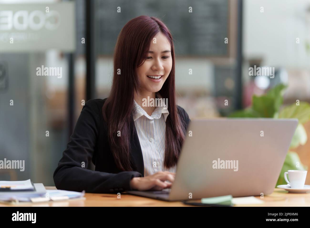 Businesswoman having a video call on laptop while discussion with ...