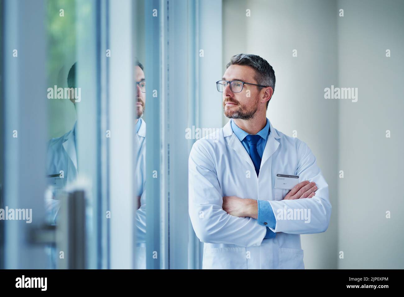 Its been a long but successful shift. a mature doctor looking out the ...