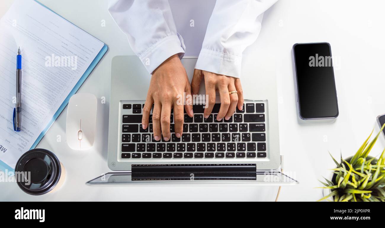 Nurse working using computer browsing internet, Closeup hands female ...
