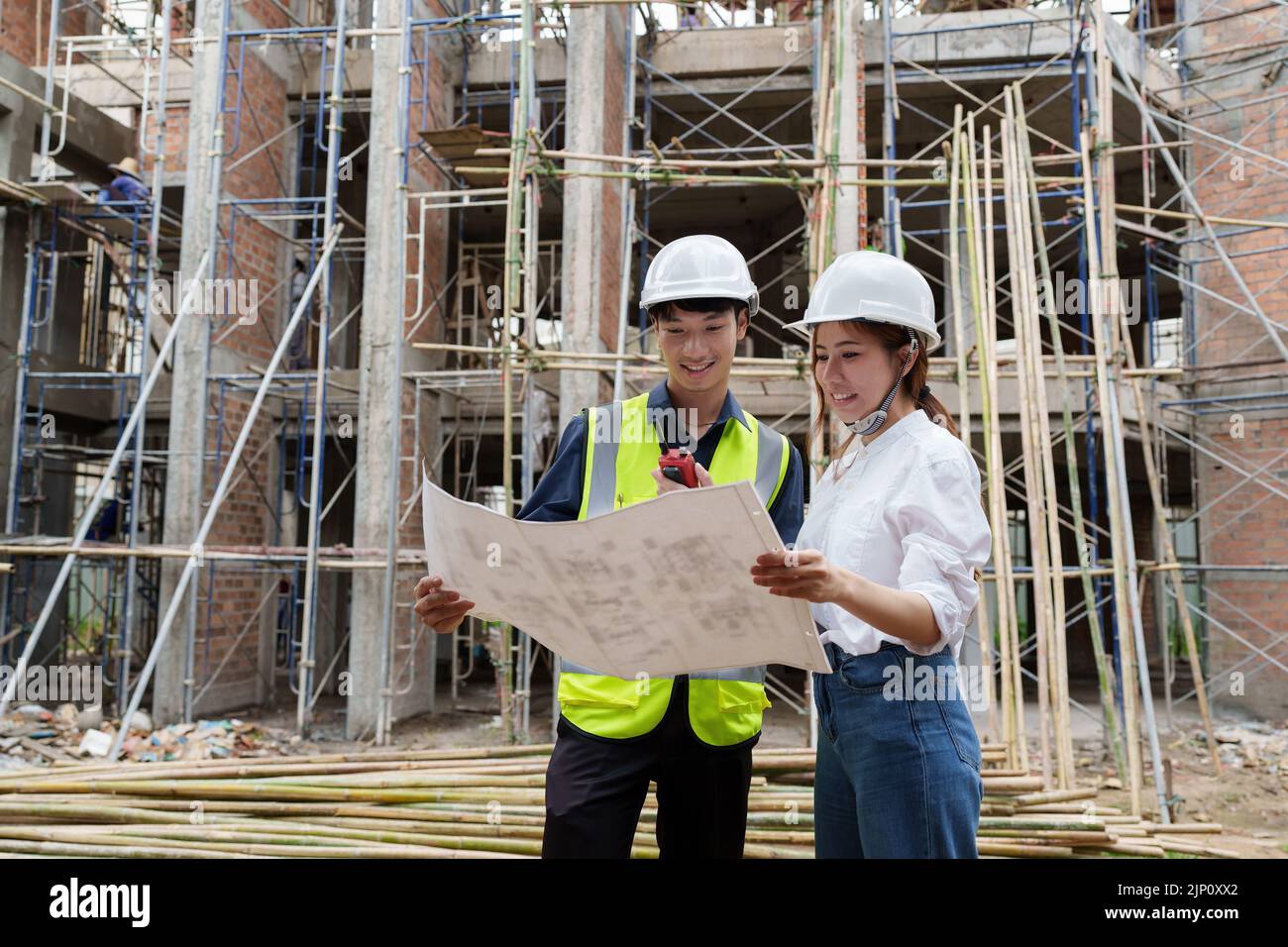 Structural engineer and architect discussing and working with ...