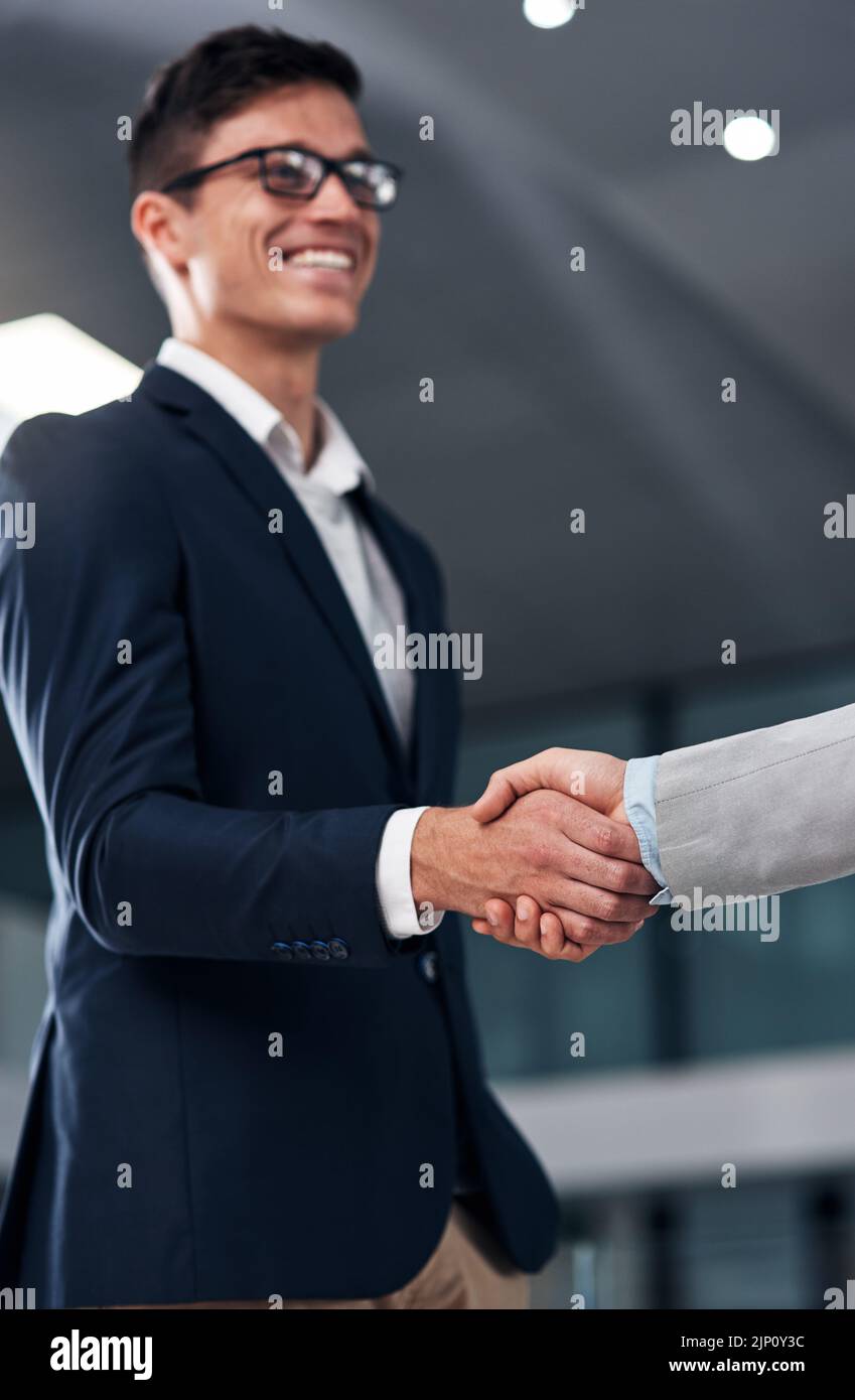 Trust plays a big role in business. two businessmen shaking hands in a ...