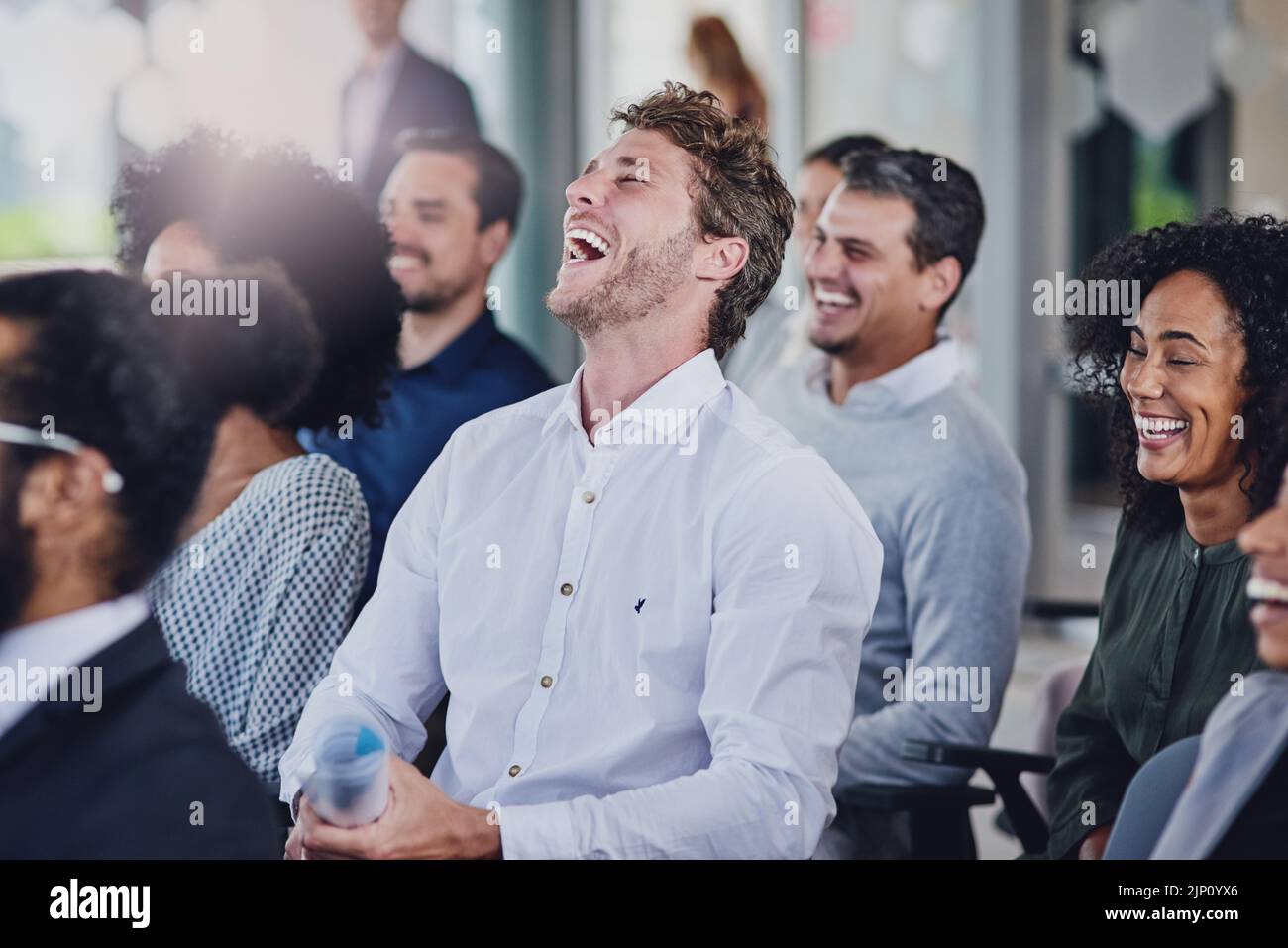 Theyre having a great time in the conference room. a group of ...