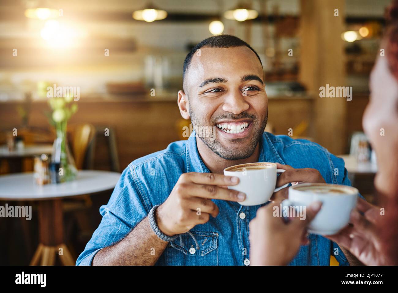 Catching up over coffee. a handsome young man spending time with his ...