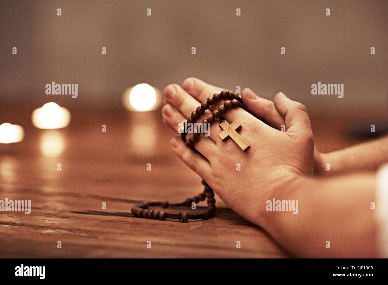 Praying man holding rosary hi-res stock photography and images - Alamy