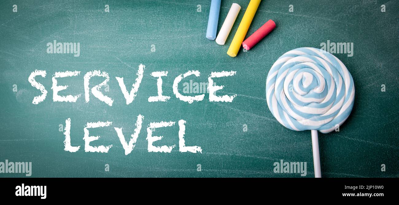 Service Level concept. Round lollipop and colorful pieces of chalk on a ...