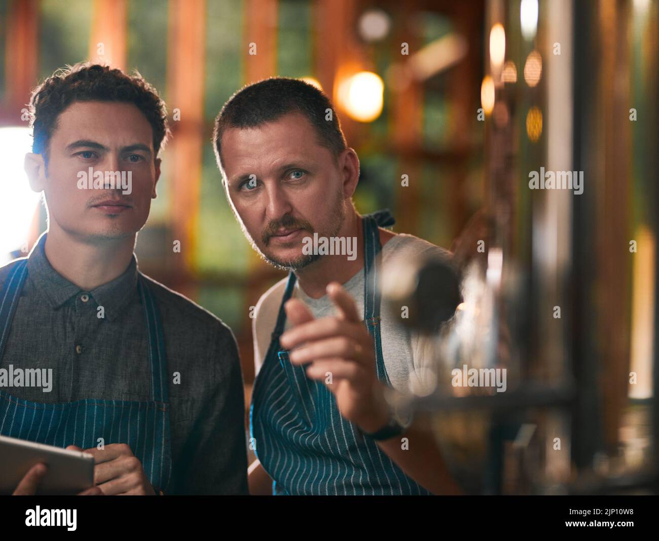 That beer there is our pride and joy. two young working men doing ...