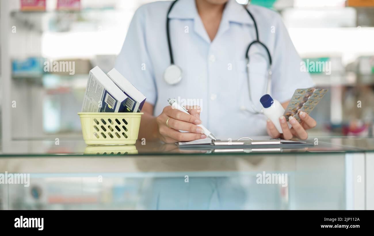 Medicine and health concept, Female pharmacist hold pill bottle and ...