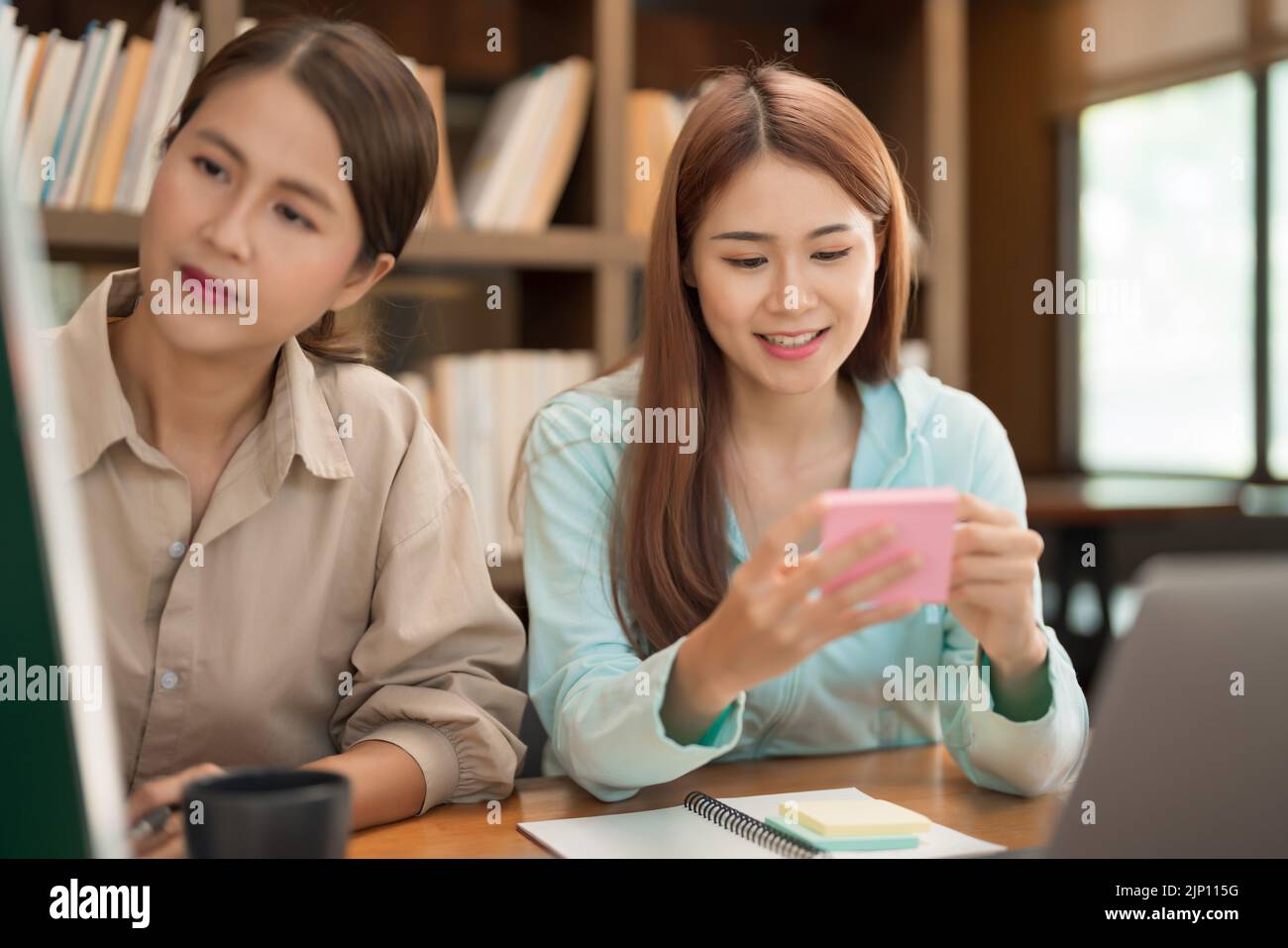College education concept, Teenage girl is writing vocabulary on sticky ...