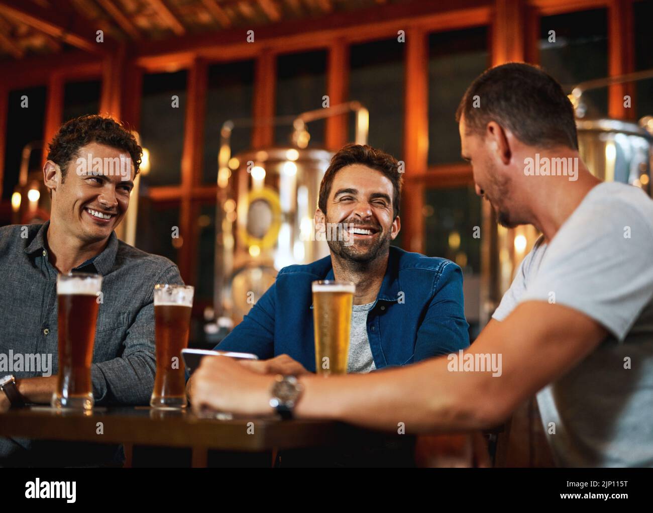 Good company, good times. a group of young friends seated at a table ...