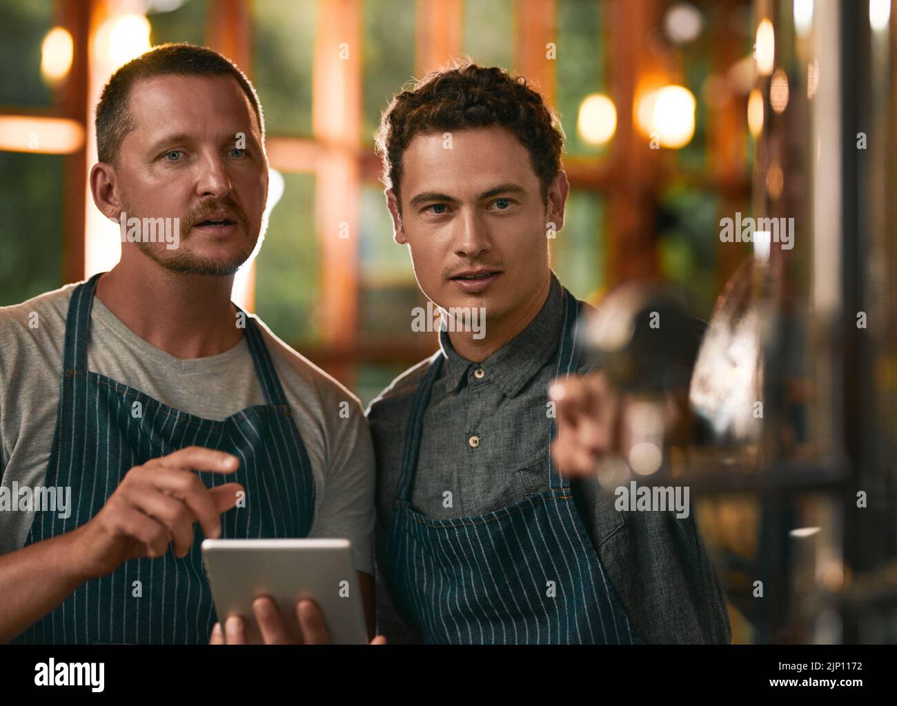 Is that your most famous beer. two young working men doing inspection ...