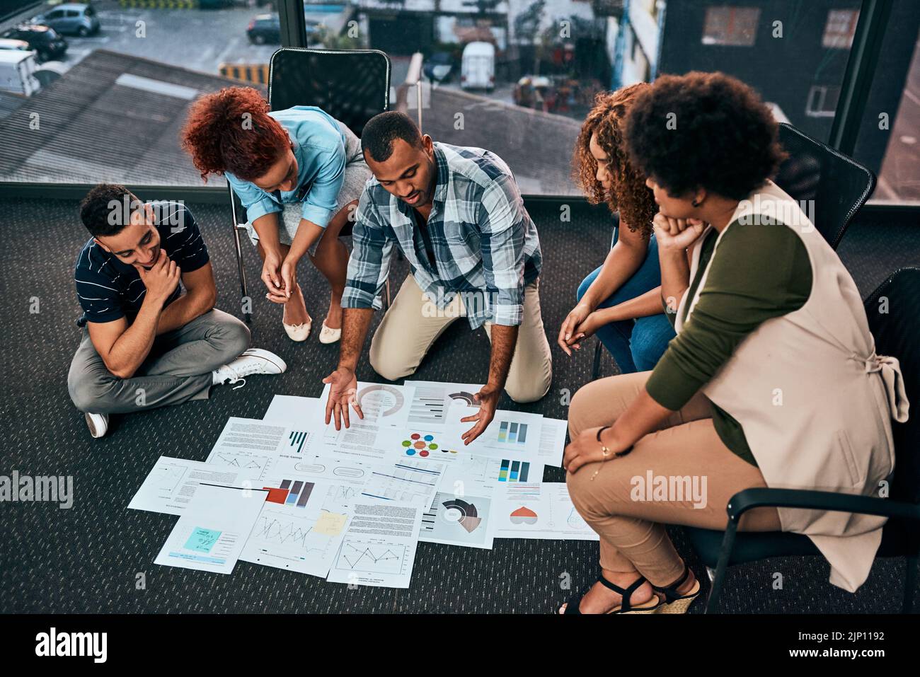 Explaining in detail. a group of focussed young coworkers working ...