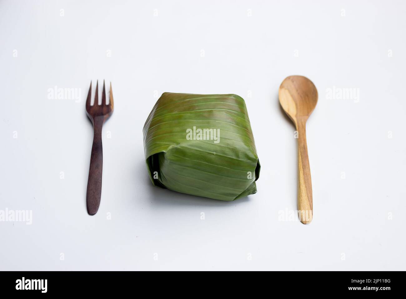 Indonesian nasi timbel or steamed white rice wrapped in banana leaf ...