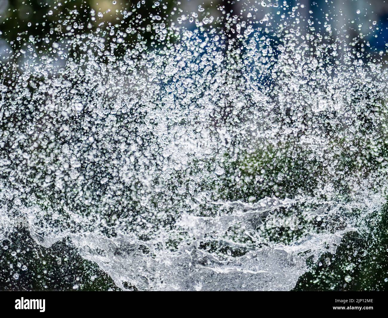 Water splashes from fountain on dark background. Natural texture of ...