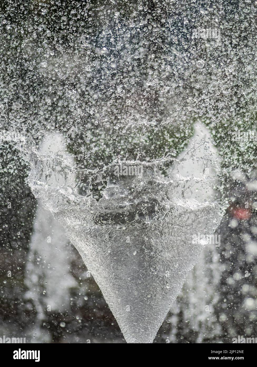 Water splashes from fountain on dark background. Natural texture of ...