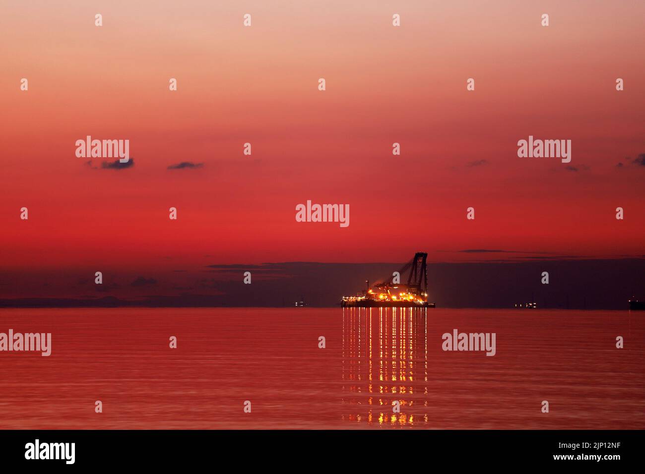 Light is reflected from the ship on the water. Sea at sunrise Stock ...