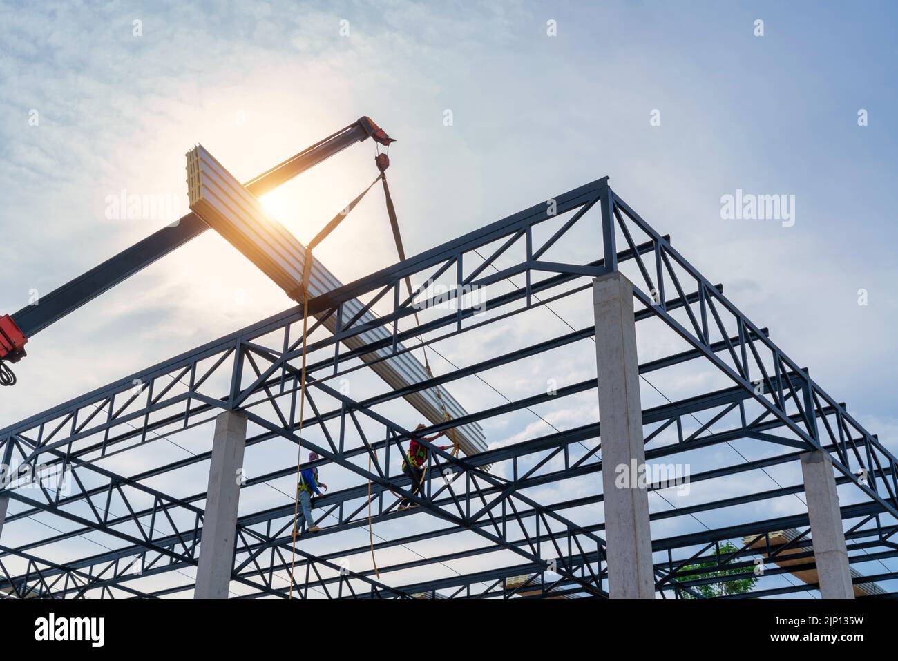 Teamwork of roofers with crane is lifting the PU foam roof sheet on the ...
