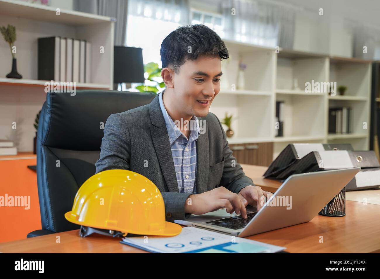 Portrait professional engineer smiles and looks in computers working ...