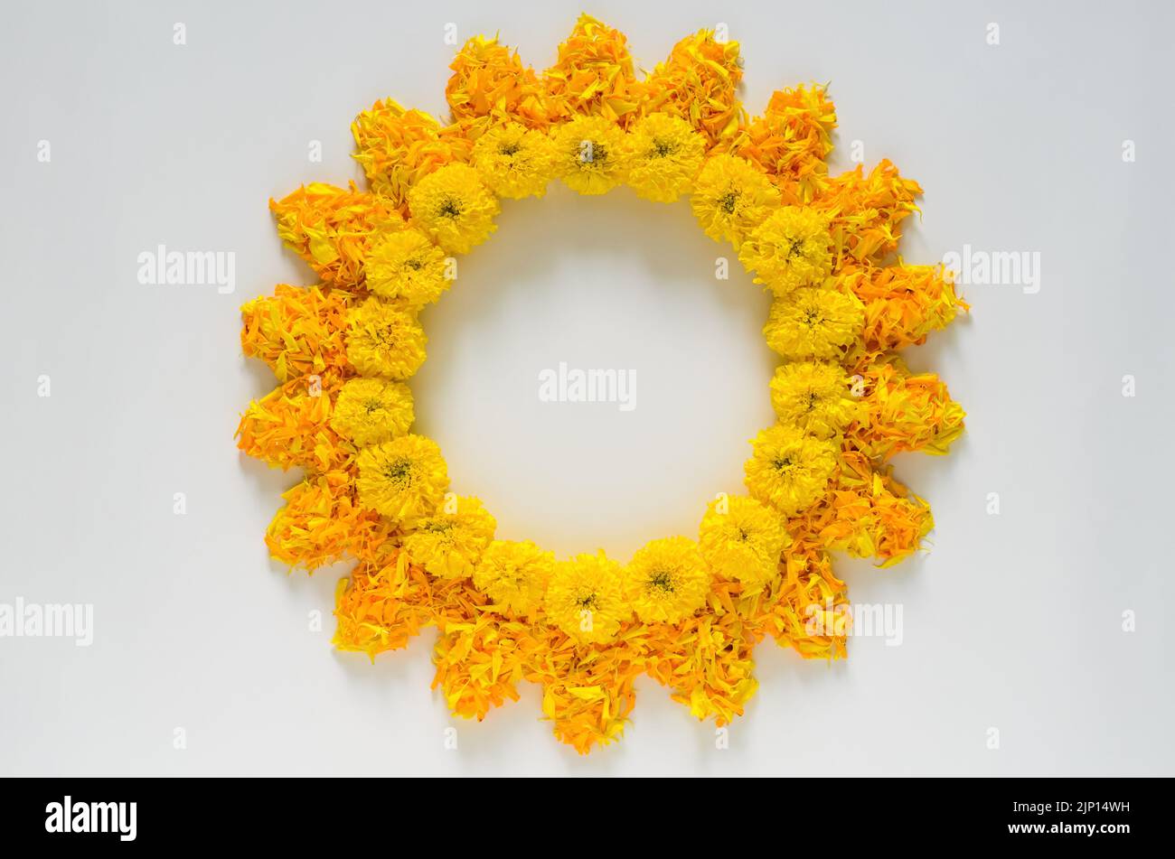 Decorative yellow and orange color marigold flowers and petals rangoli ...