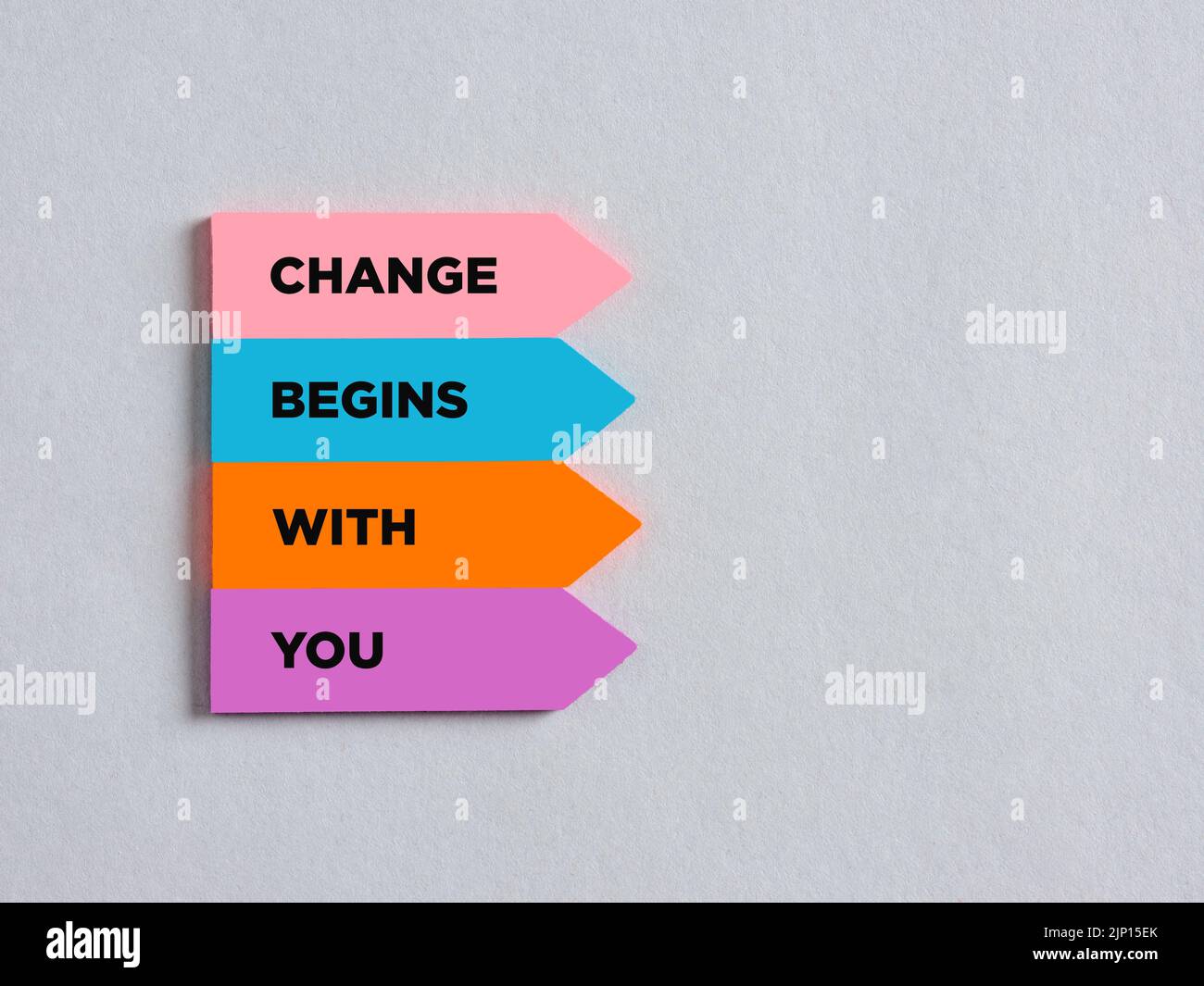Colorful arrow shaped stickers with the message change begins with you ...