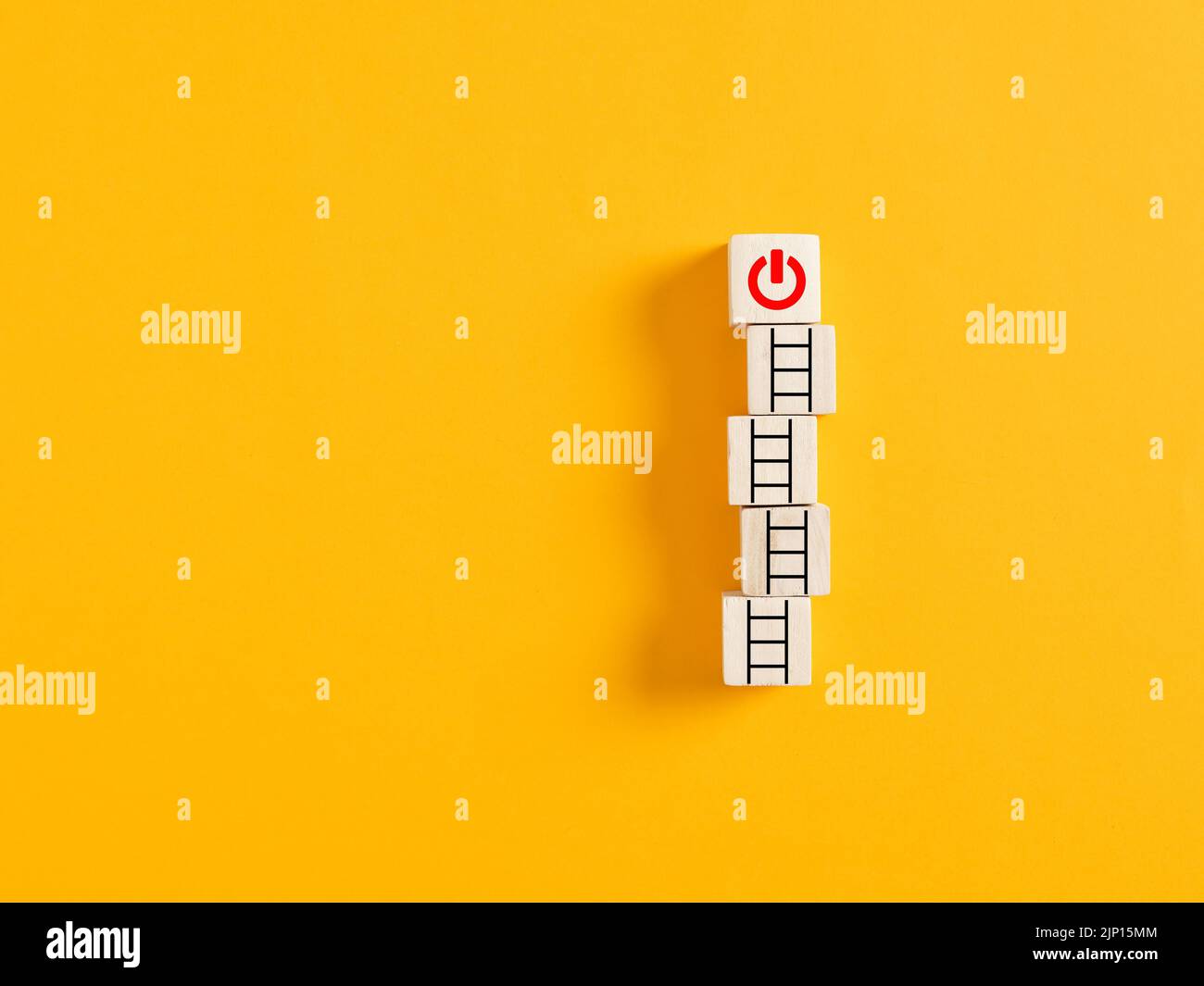 Ladder of success with wooden cubes and power button. Building a start ...