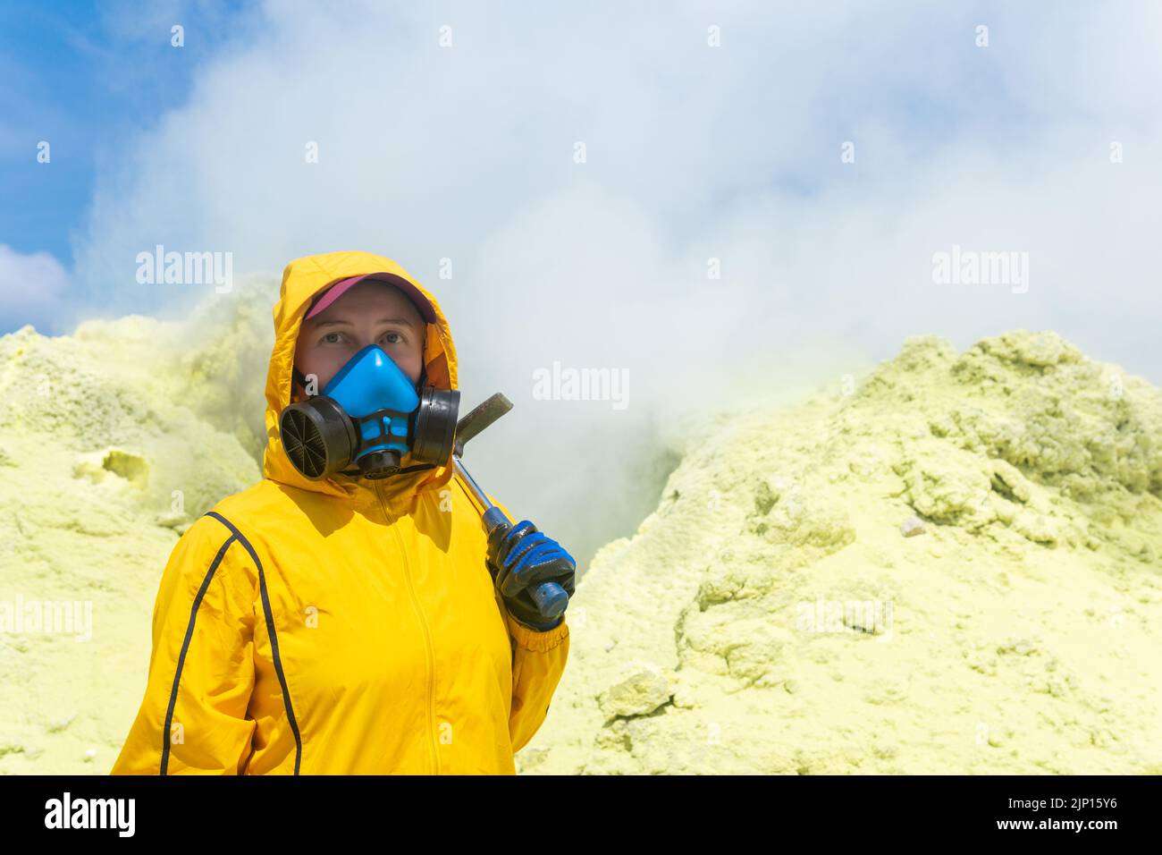 woman volcano scientist with a geological hammer and in a respirator ...
