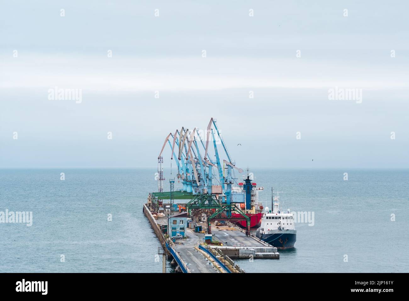 cargo berth with port cranes and moored ships against the backdrop of ...