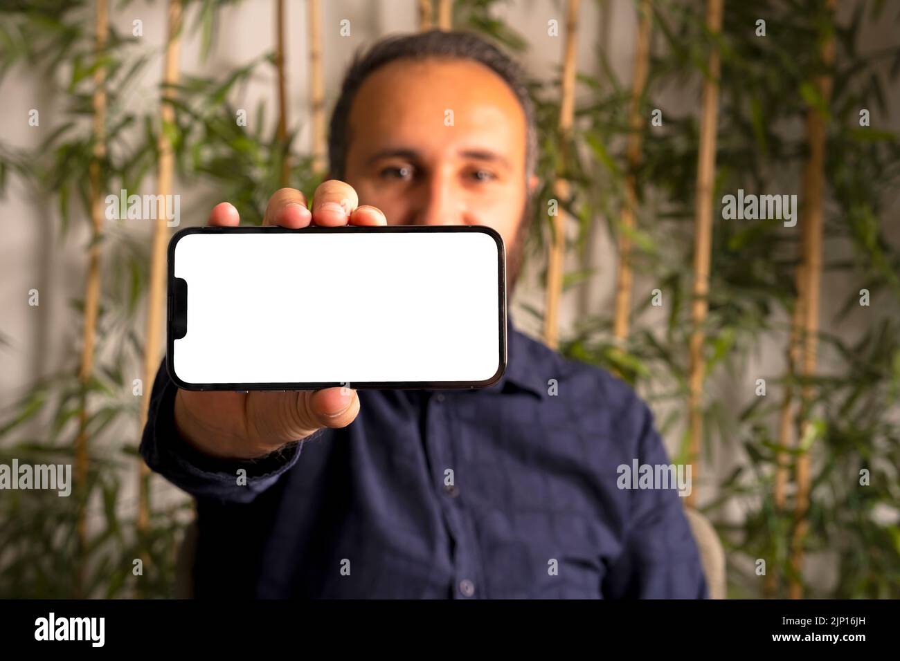 Holding smartphone, caucasian man holding smartphone horizontal. White ...