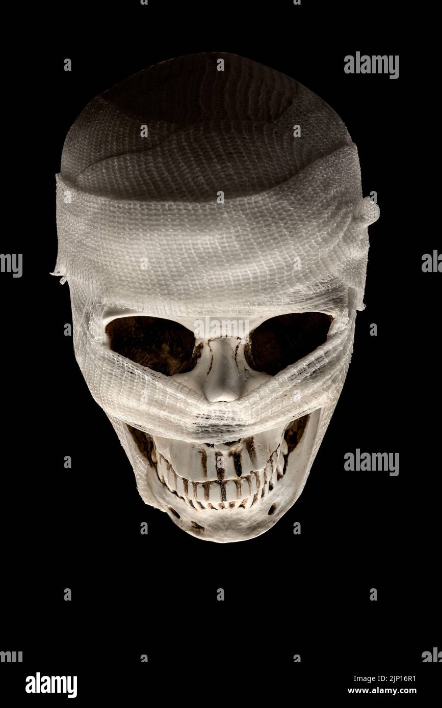 Mummy with skull head on black background Stock Photo - Alamy