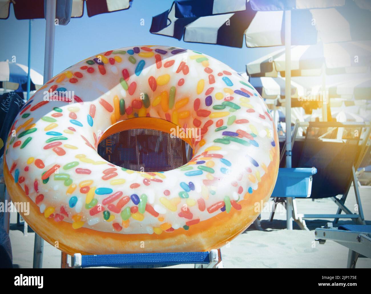Inflatable donut toy at the Italian beach. Concept of summertime and ...