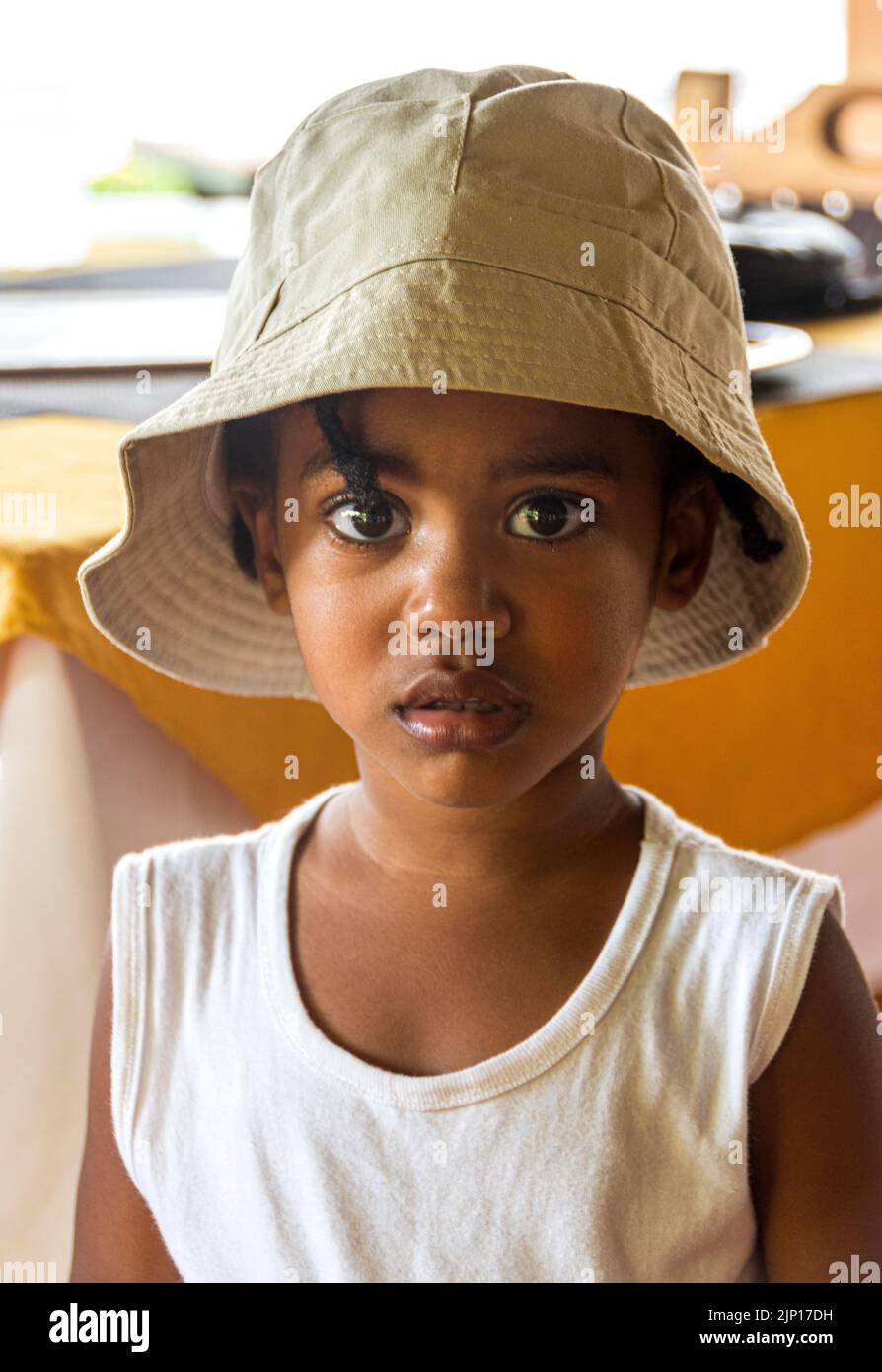 A cute, little Cuban boy at a restaurant with his Cuban parents waiting ...