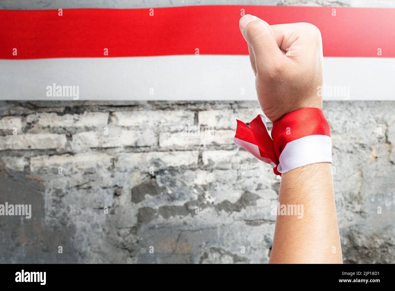 Human hand showing ribbon with the red and white color of the ...