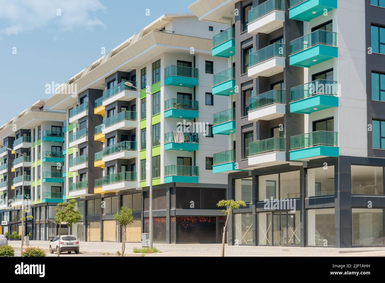Modern freshly built apartment buildings on a sunny day with blue sky ...