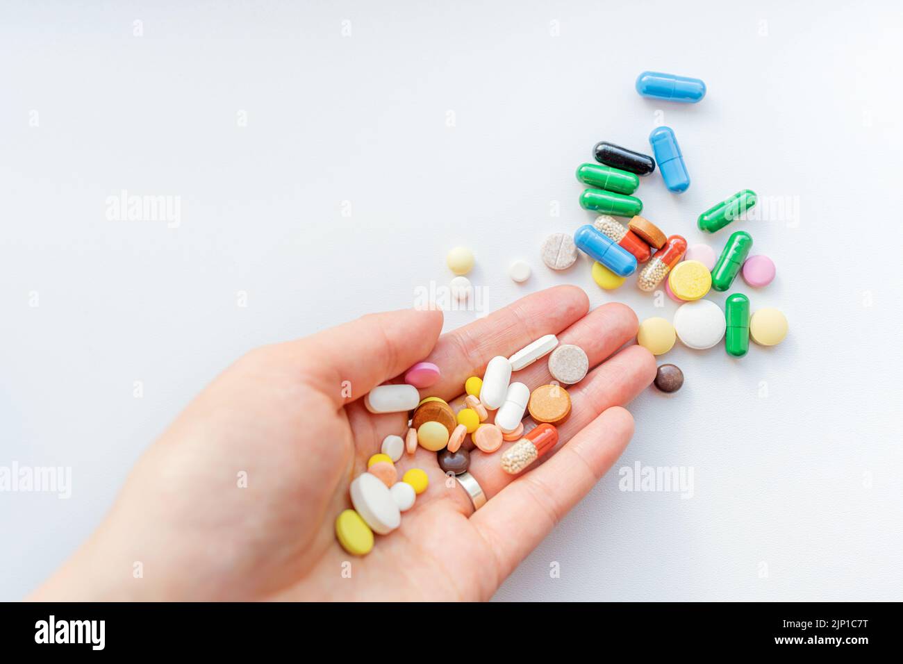 Hand full of colorful pills Stock Photo - Alamy